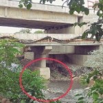 A concrete pillar amidst Pili Nadi near Mankapur obstructing flow of ...